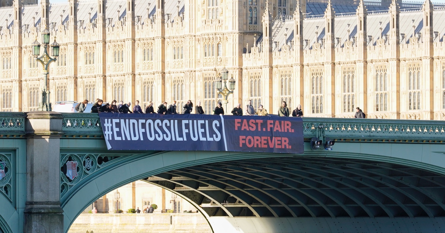 Activists kick off week of climate protests with banner drop on ...